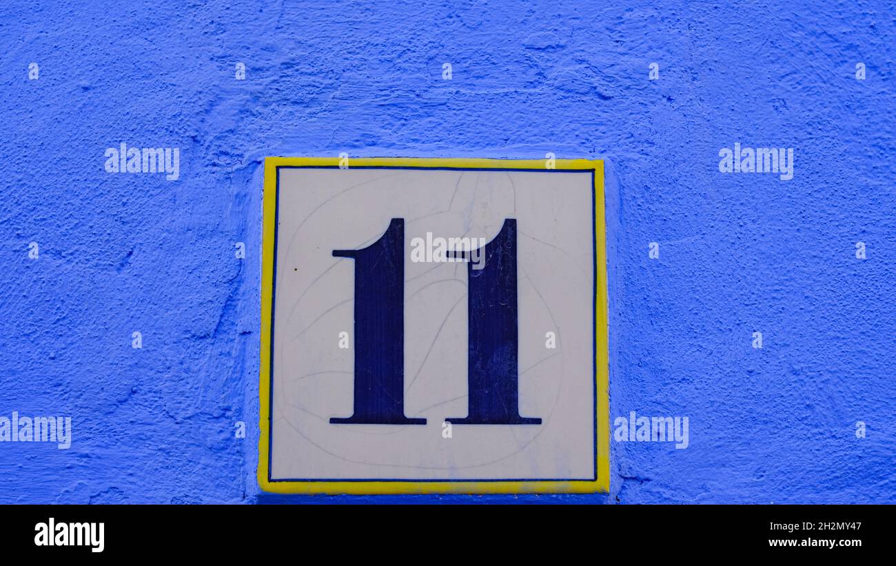 ceramic house number table. number: 11 on a blue background Stock Photo ...