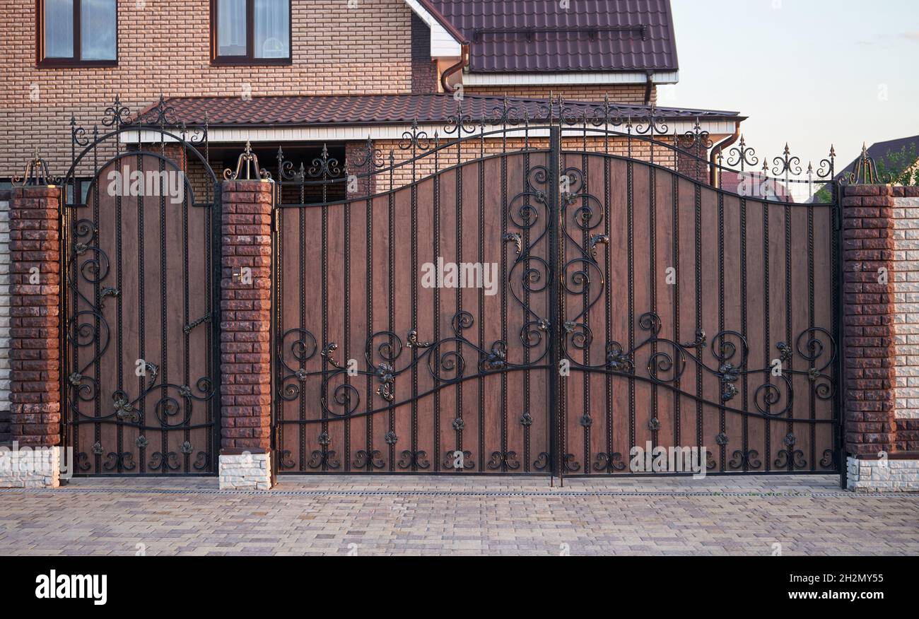 Wrought metal gates with ornate lines in a private house Stock Photo ...