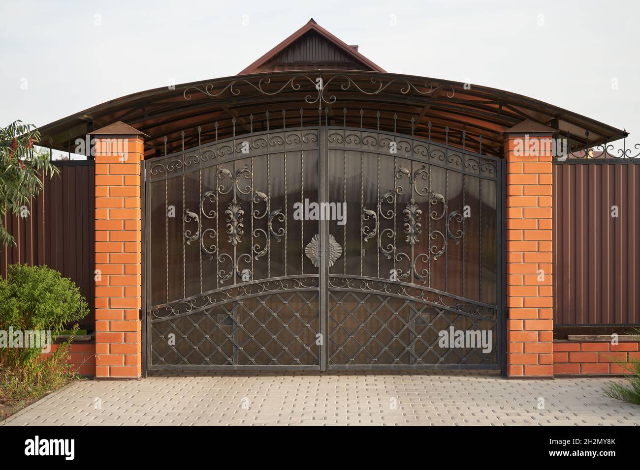 Forged gates with a canopy in a private house Stock Photo - Alamy