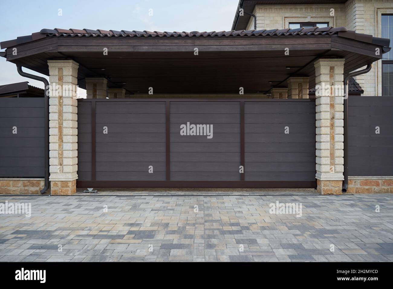 Sliding plastic gates with a canopy in a private house Stock Photo - Alamy