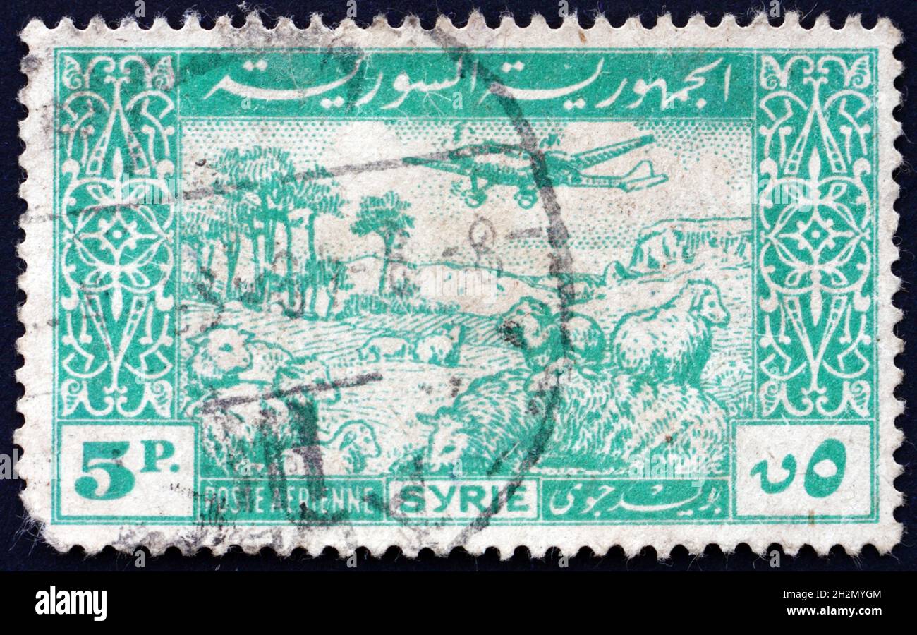 SYRIA - CIRCA 1947: a stamp printed in Syria shows Plane and Flock of ...