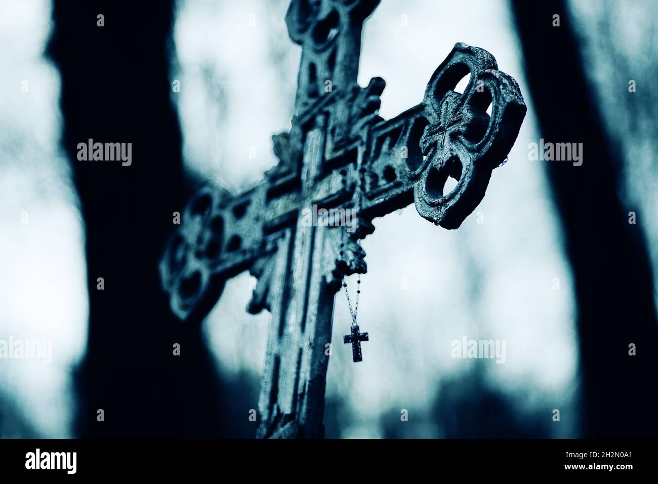 A beautiful, old Catholic cross in the cemetery, on which a rosary is ...