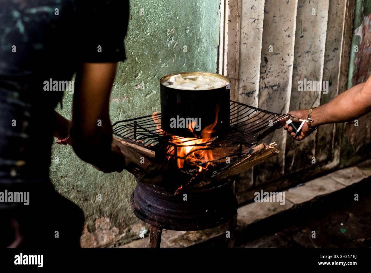 Salvador, Bahia, Brazil - June 29, 2019: Men cooking cassava in an iron ...