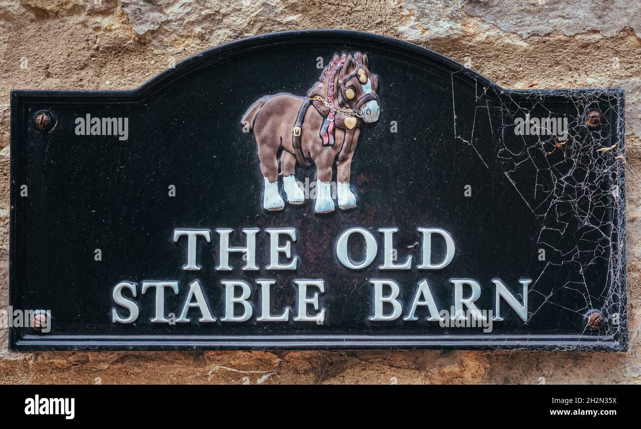 Closeup of "The Old Stable Barn" sign on stone wall Stock Photo - Alamy