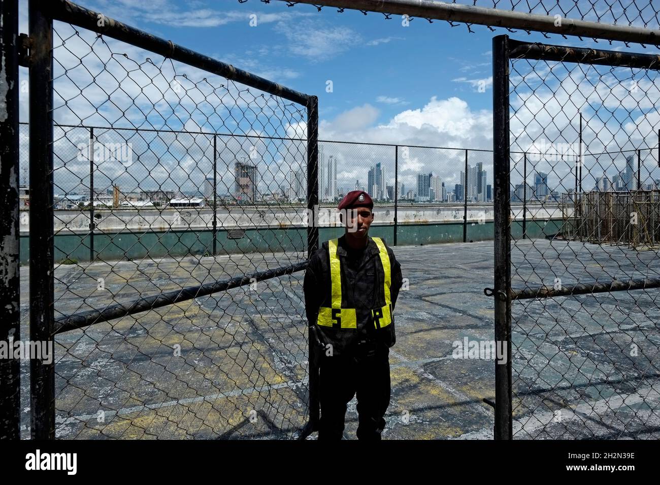 An armed security man stands guard at the entrance to a basketball ...