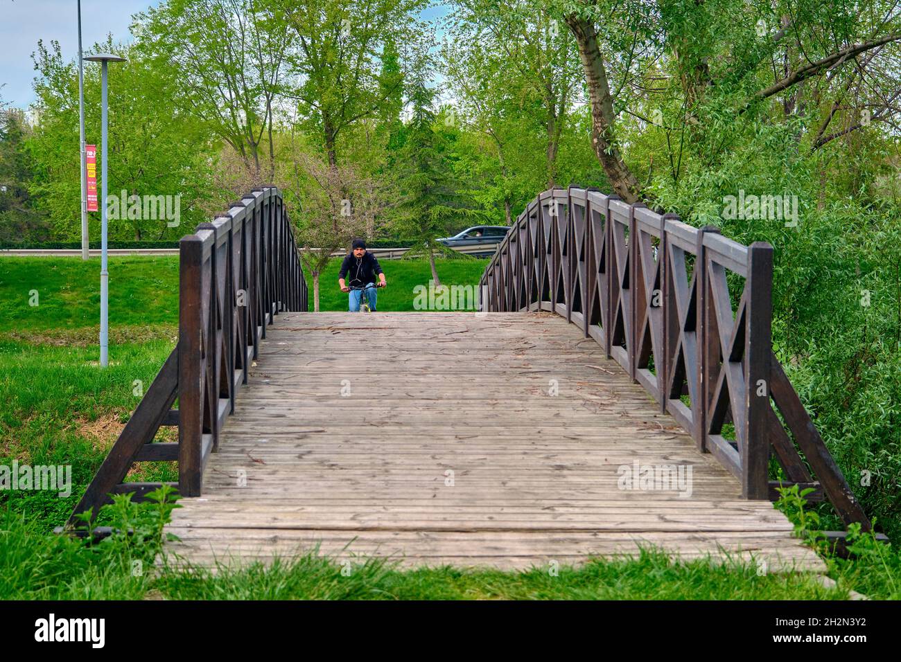 Small vintage bridge inside green grass. Bridge made of wooden material ...