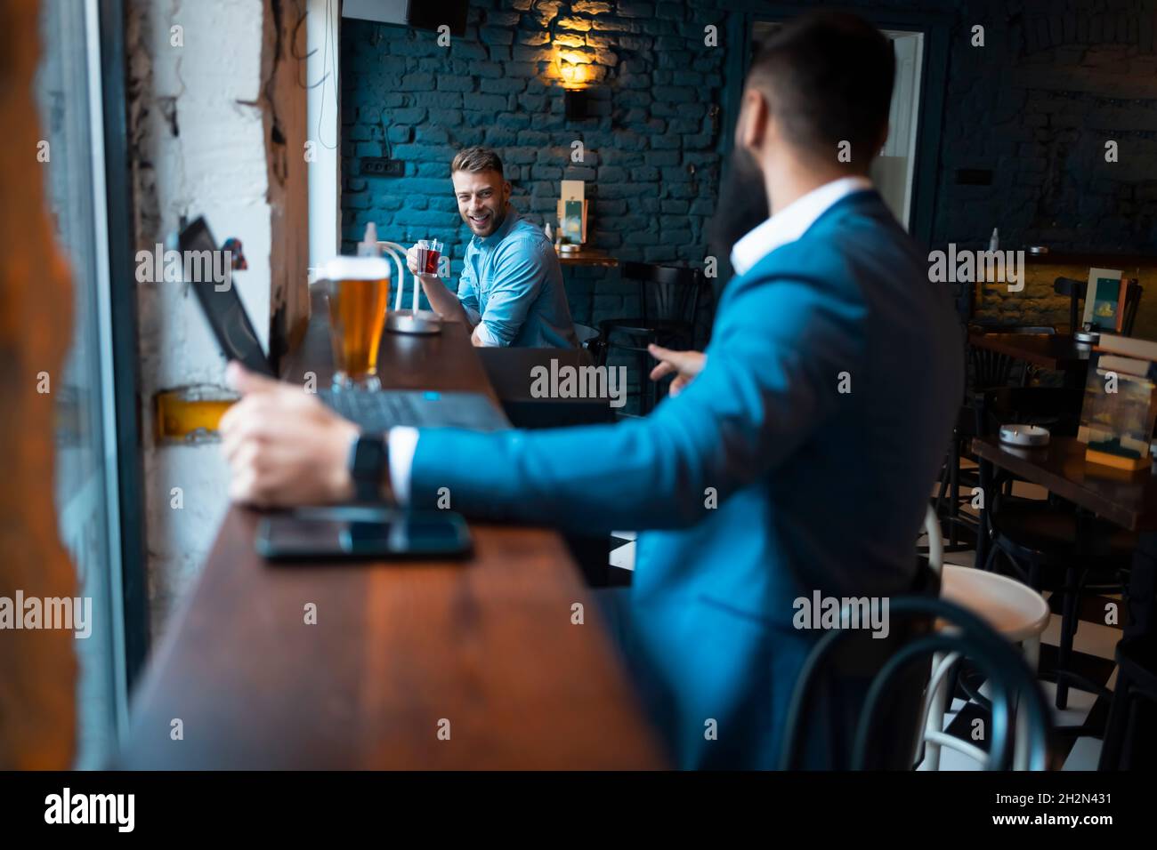Two friends chatting in a bar Stock Photo - Alamy