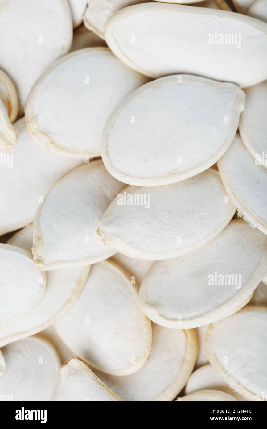 Pumpkin seeds in a shell as a textural background. full screen super ...
