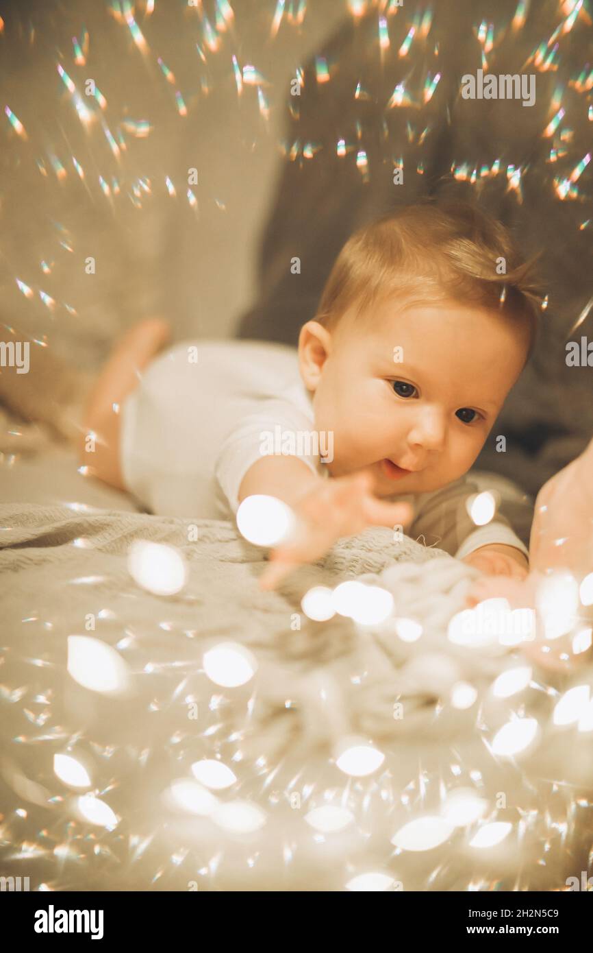 Cute baby with rays of light Stock Photo - Alamy