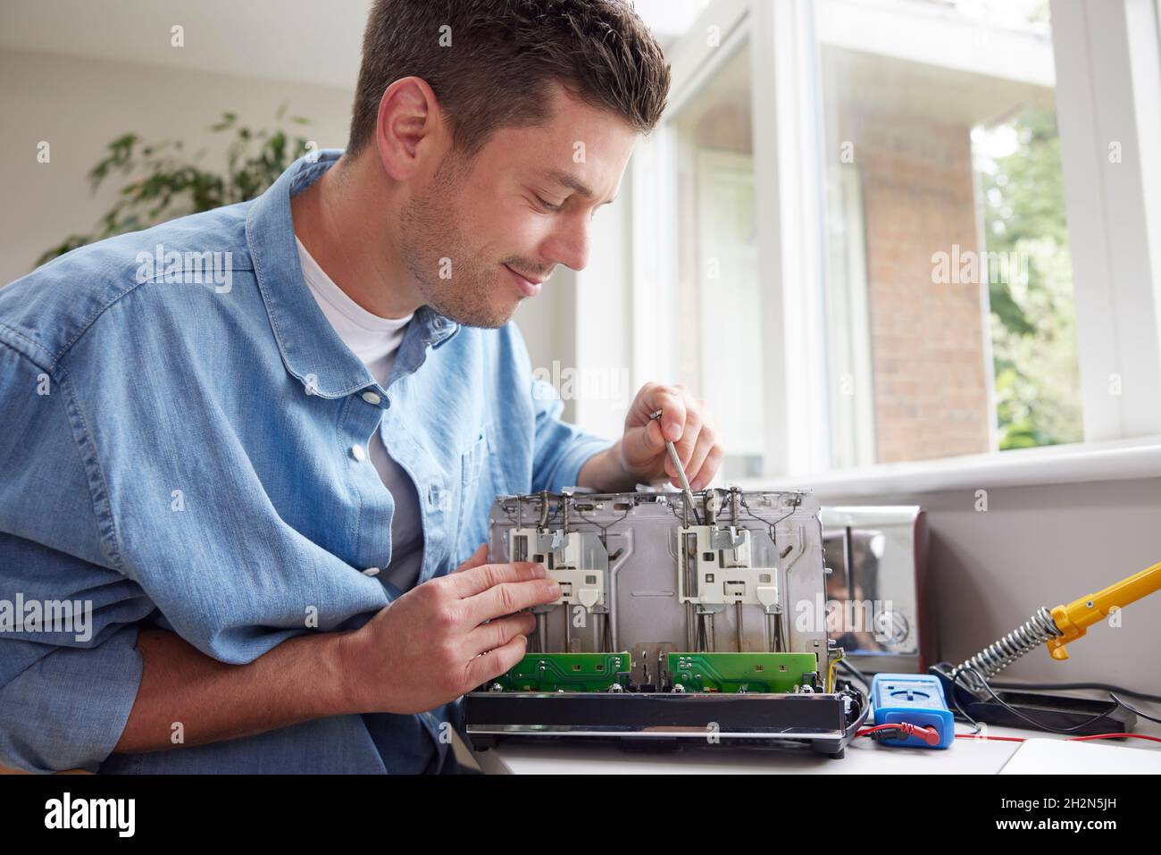 Man Fixing Electric Toaster Rather Than Buying New Product Sustainable ...