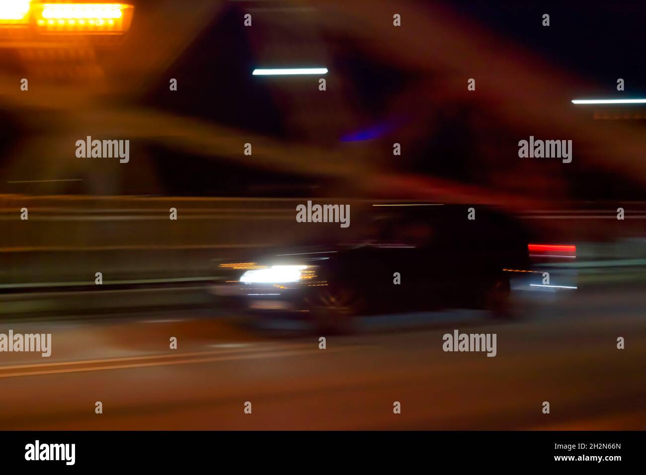 Blurred motion of car driving at night Stock Photo - Alamy