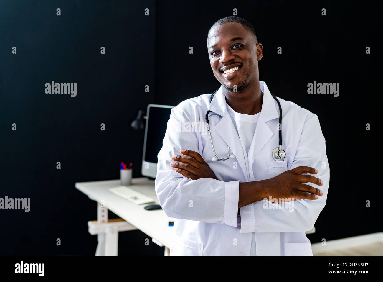Mid adult male doctor with clipboard at medical clinic Stock Photo - Alamy