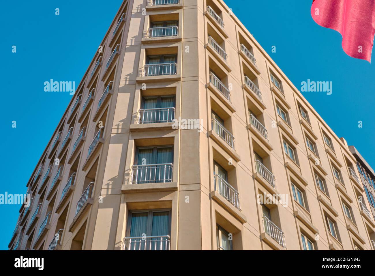 Corner shape of modern architecture building and many windows behind ...
