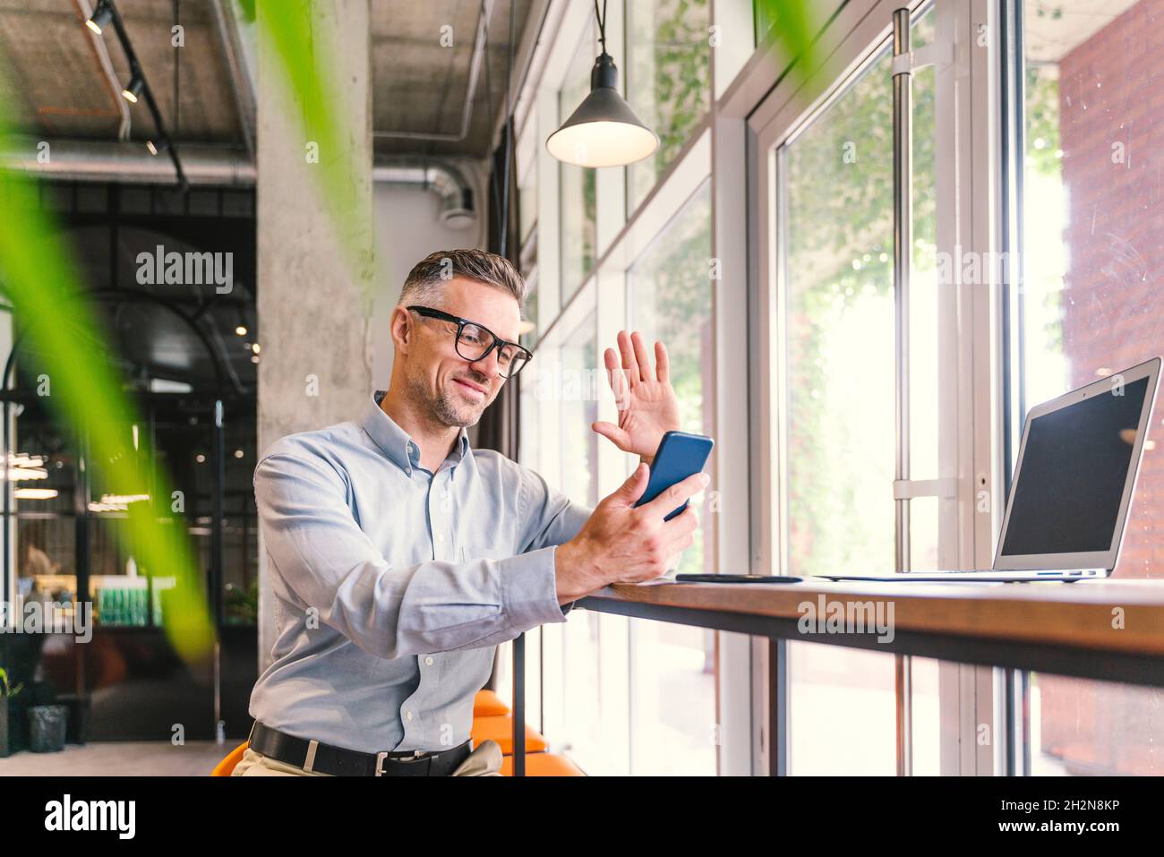Mature man glasses waving hand hi-res stock photography and images - Alamy