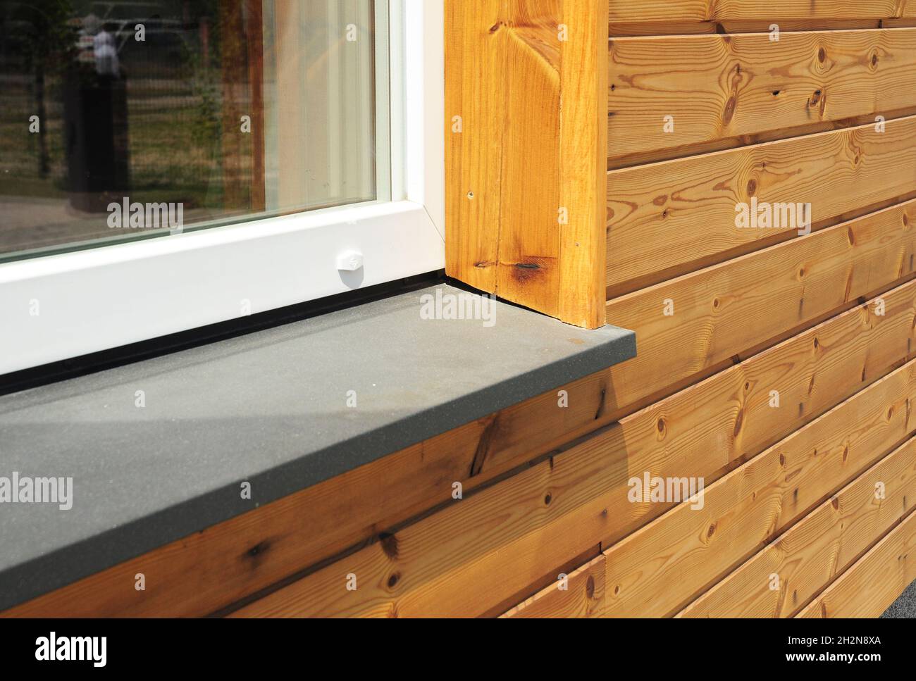 Window Sill with Modern Wooden Facade Wall. Single plastic window sill ...