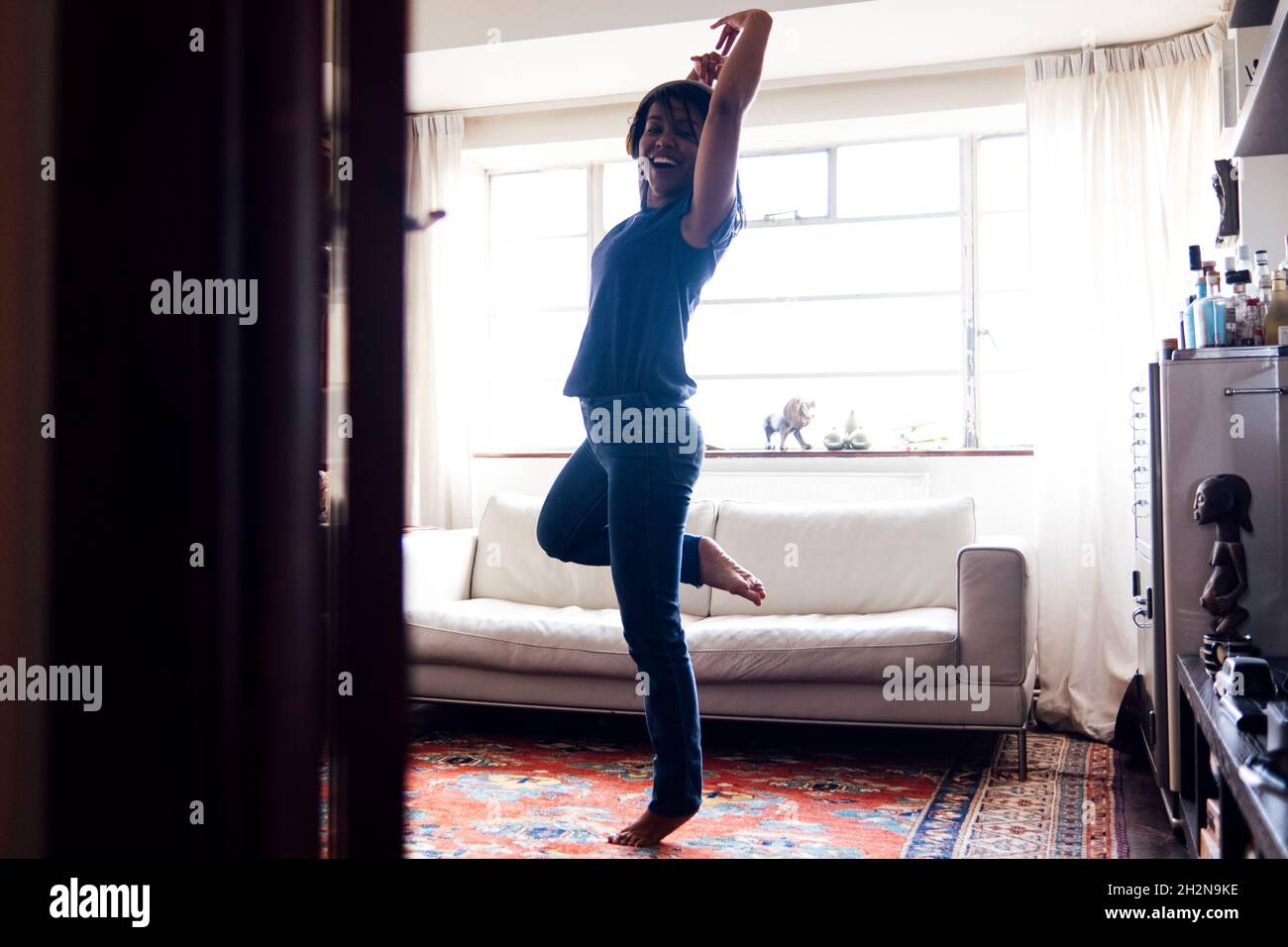 Cheerful woman dancing at home Stock Photo - Alamy