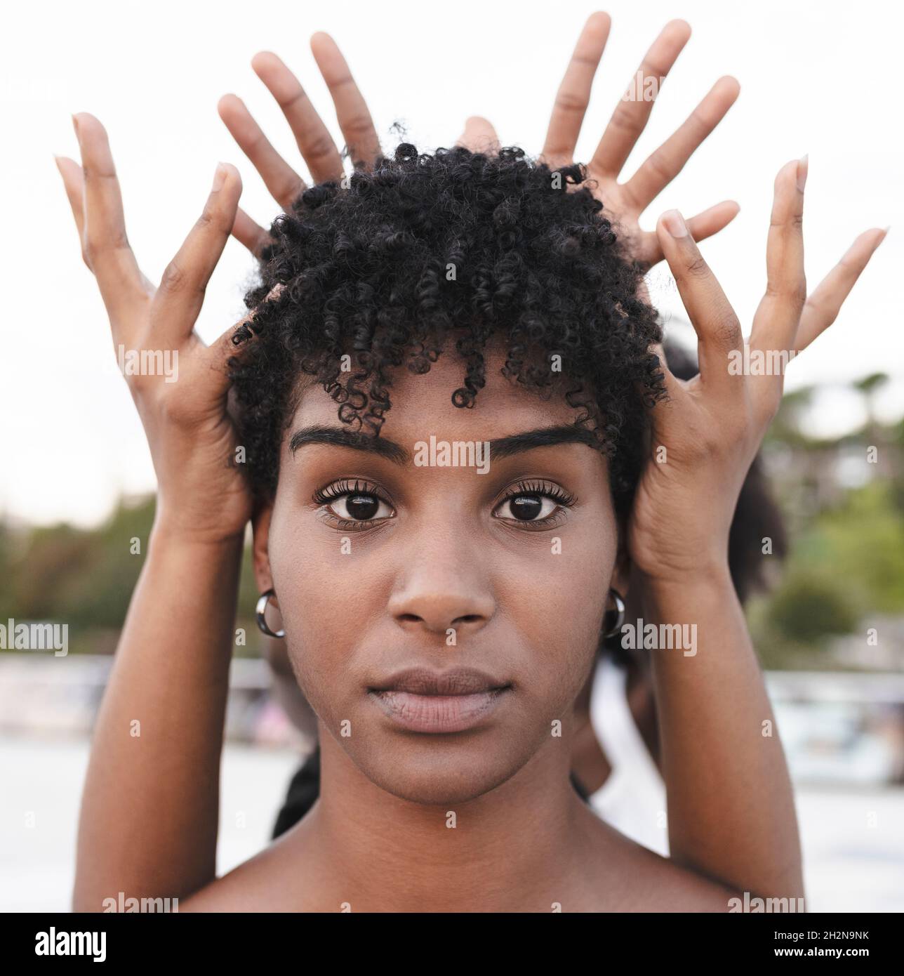 Hands touching face of woman with eyes closed Stock Photo - Alamy
