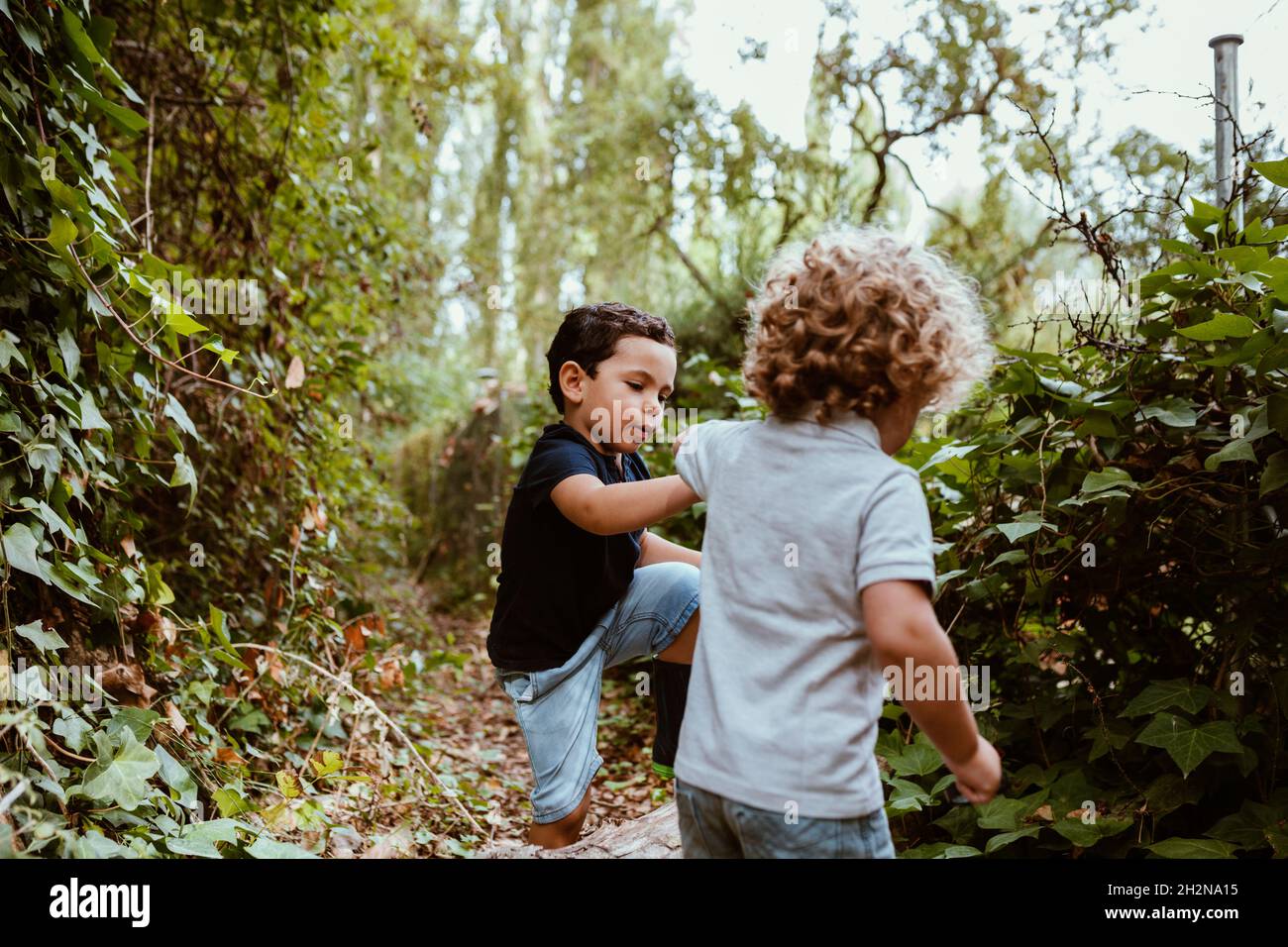 Three children stand hi-res stock photography and images - Alamy