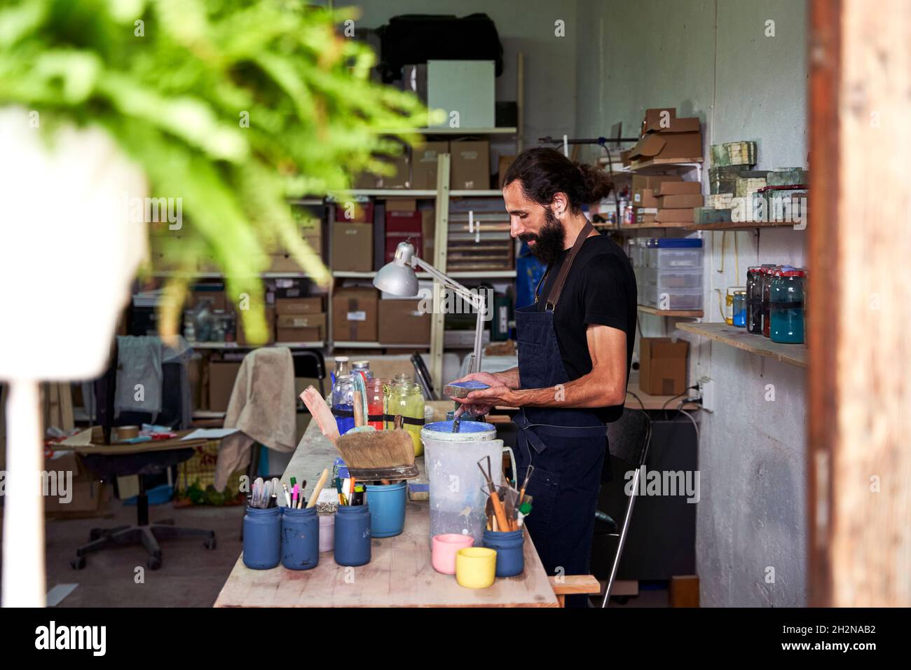 Male store owner working in concrete workshop Stock Photo - Alamy
