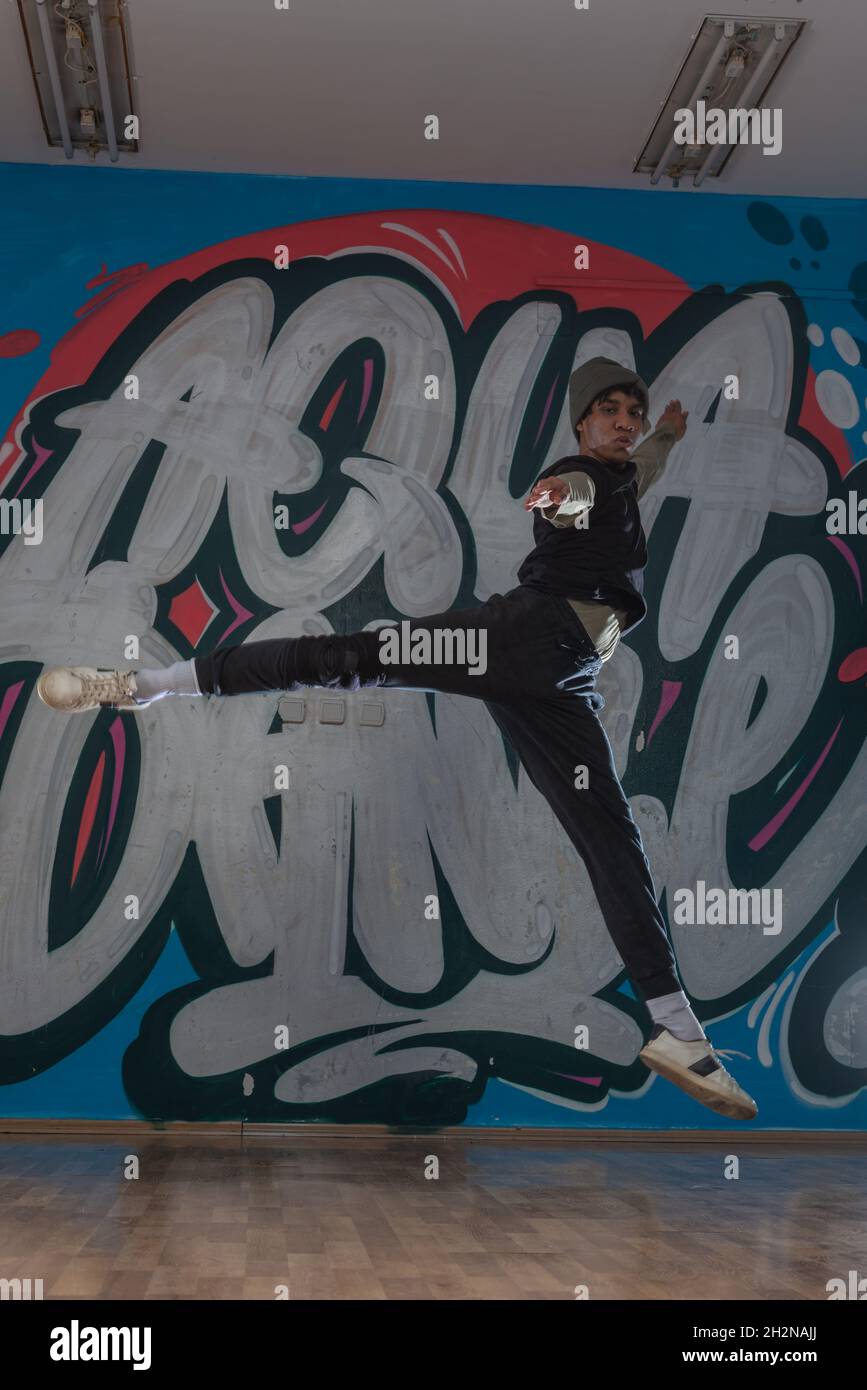 Modern rapper dancing in garage. Urban lifestyle, hip hop Stock Photo ...