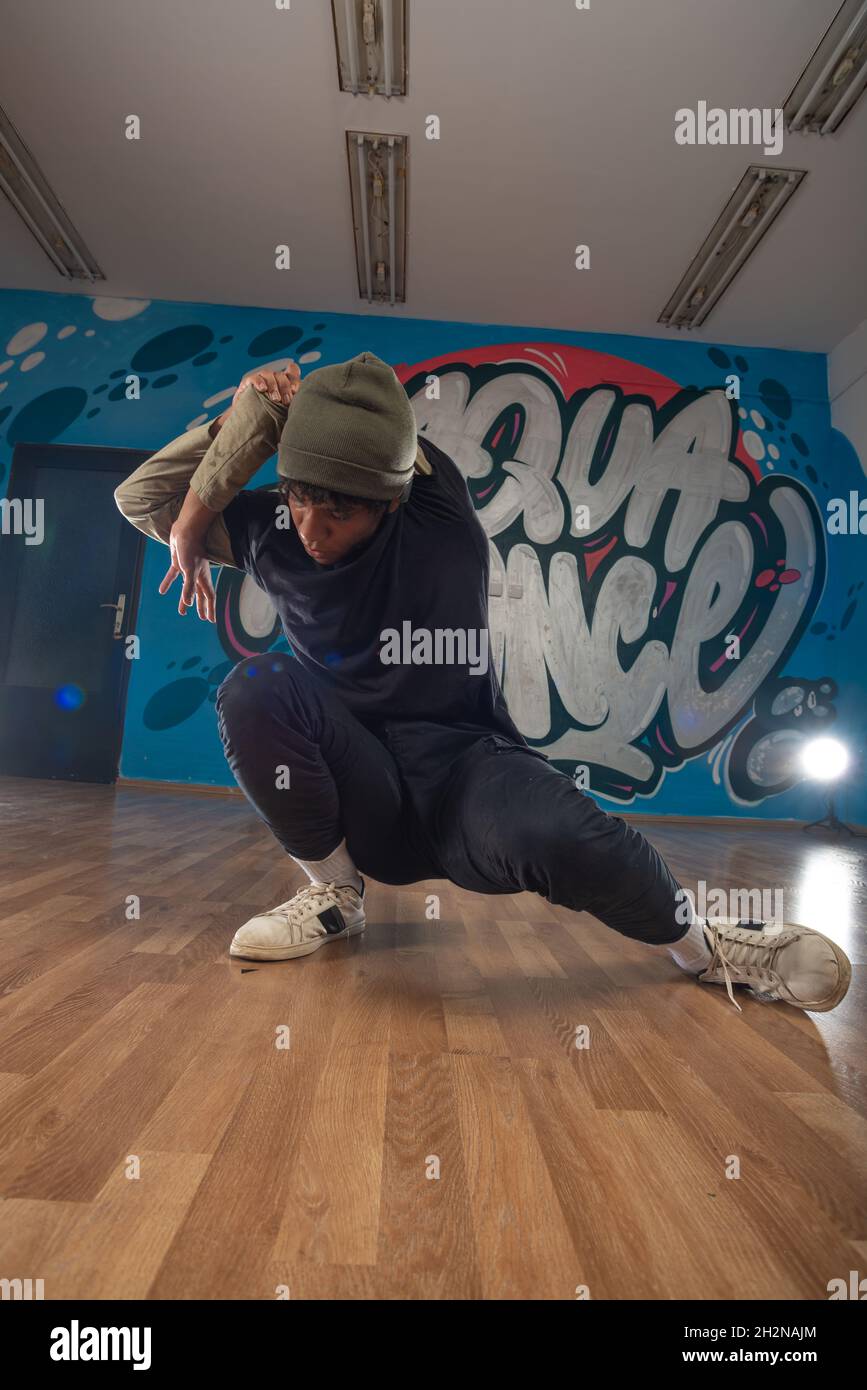 Modern rapper dancing in garage. Urban lifestyle, hip hop Stock Photo ...
