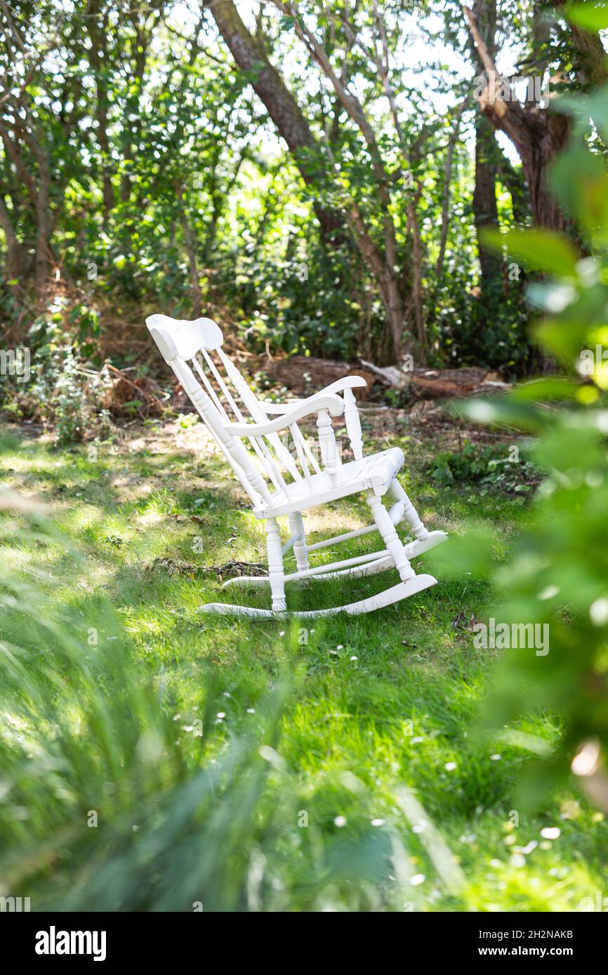 Empty rocking chair standing in summer backyard Stock Photo - Alamy