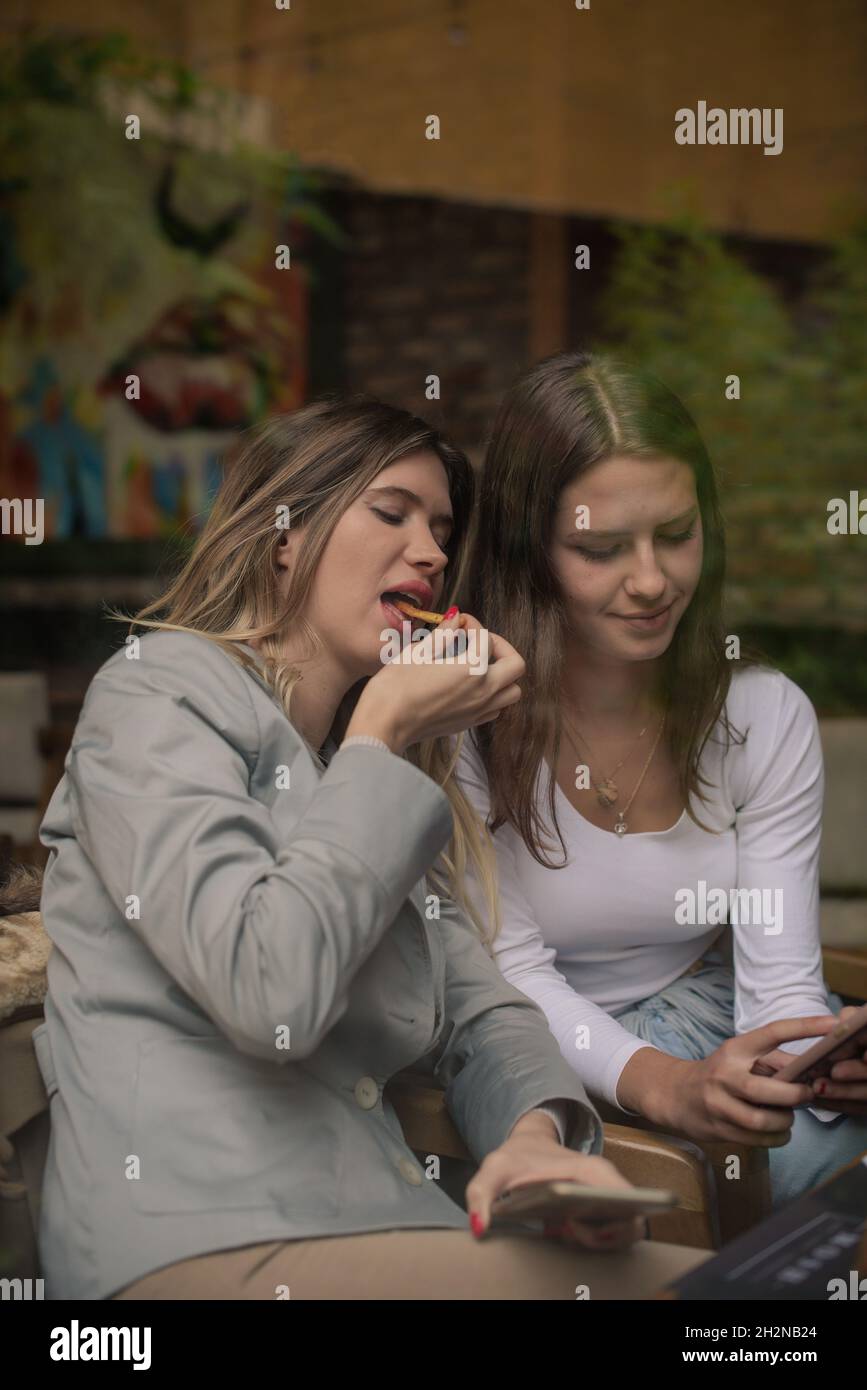 Amazing girls are eating together while taking pictures of themselves ...