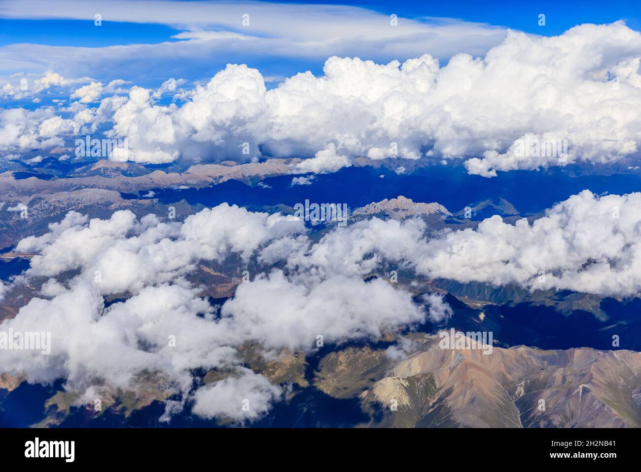 Aerial view above the clouds and mountain peaks on a sunny day.mountain ...