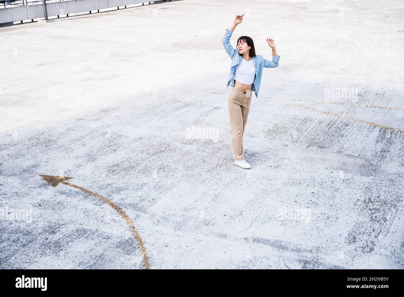 Teenage girl with arms raised dancing on rooftop Stock Photo - Alamy