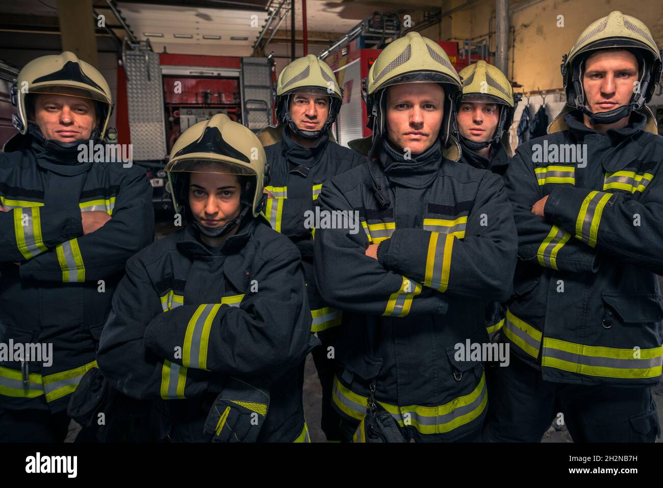 Group of firefighters standing confident with arms crossed. Firemen ...