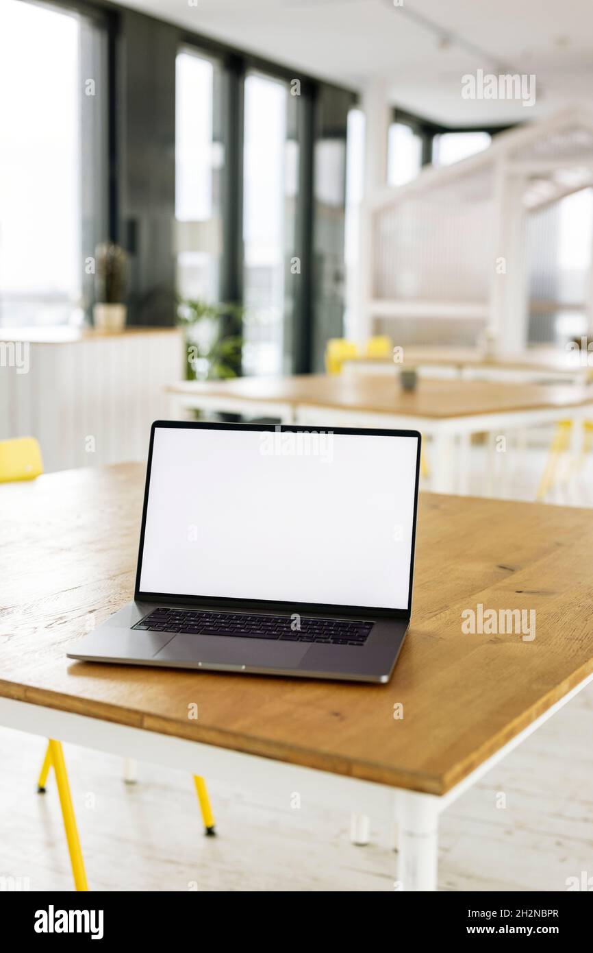 Laptop placed on desk in workplace Stock Photo - Alamy