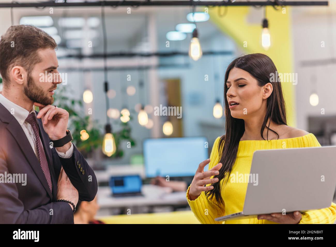 Manager explaining to his employee how to finish her tasks. Colleagues ...