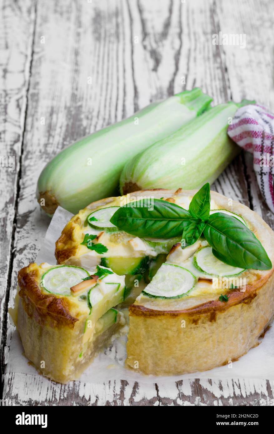 Courgette and feta cheese quiche on white wooden table Stock Photo - Alamy