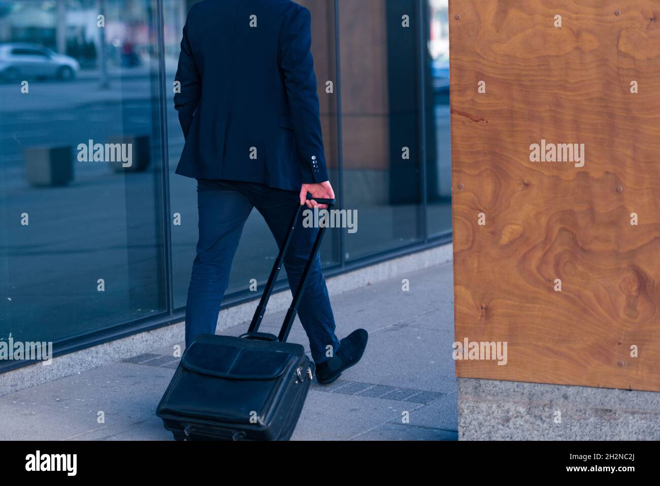 Close up photo a formal businessman dragging his suitcase, manbag, pull ...