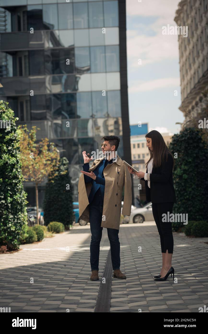 Businessman is showing the new location while the businesswoman is ...