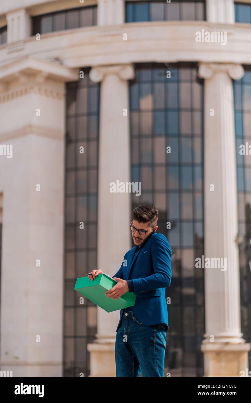 Modern lawyer talking on cellphone during walking in the city center ...