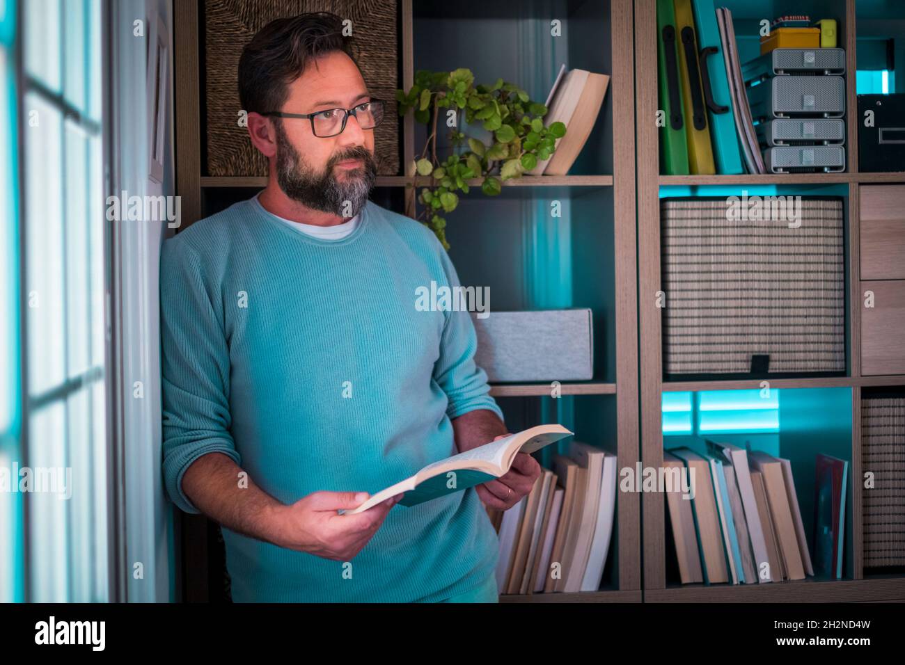 Man taking a book from shelf hi-res stock photography and images - Alamy