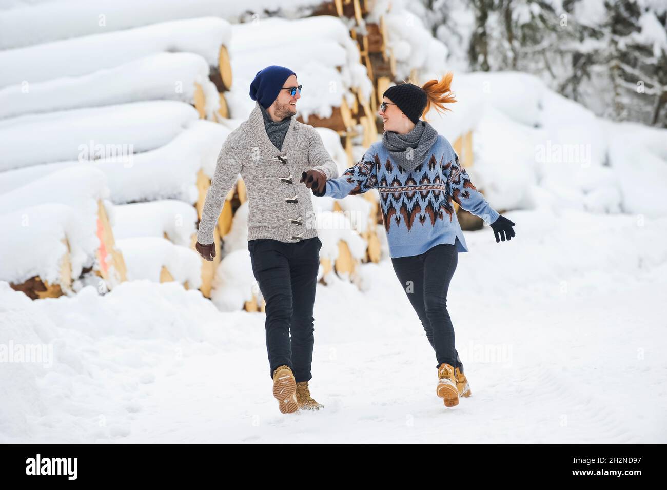 Happy couple enjoying during snow in winter Stock Photo - Alamy
