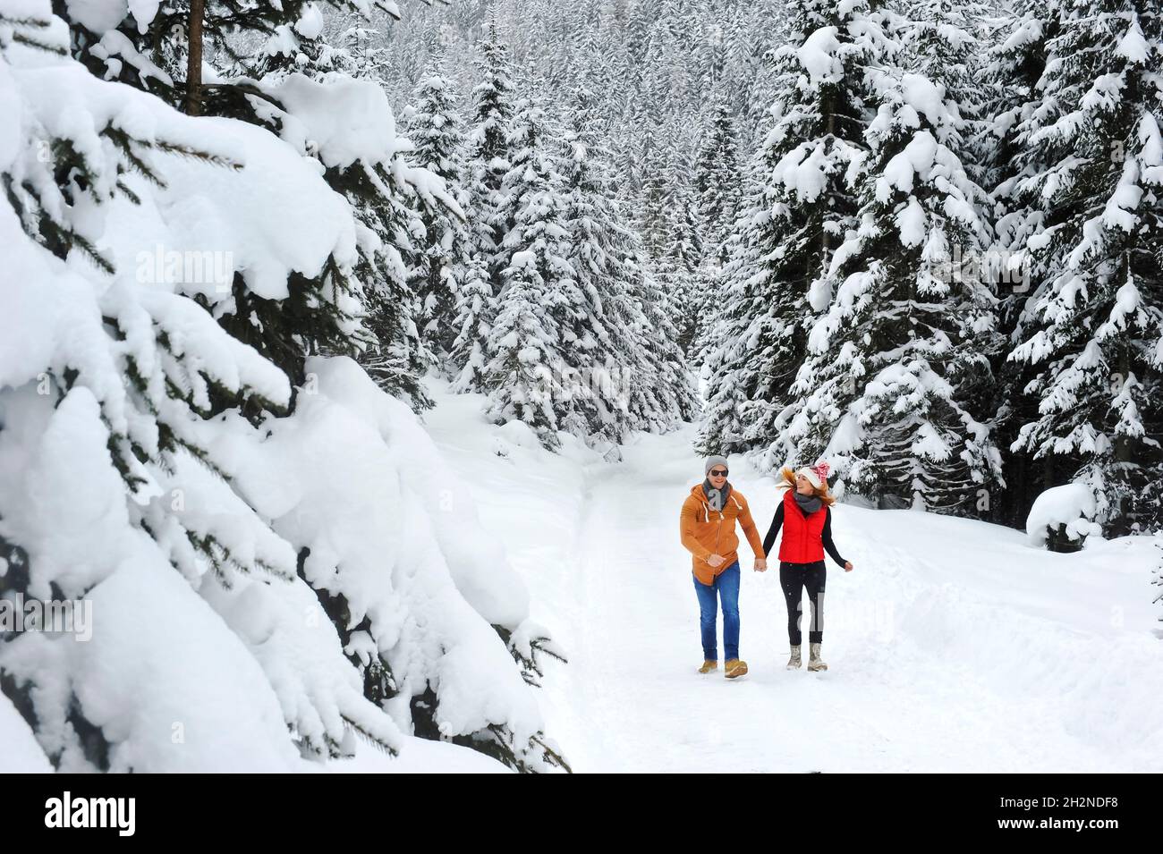 Couple enjoying in snow during vacation Stock Photo - Alamy