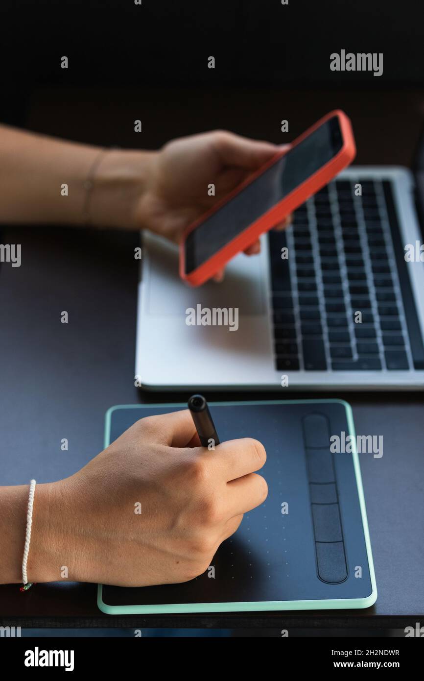 Female student using graphic tablet and mobile phone at cafe Stock ...