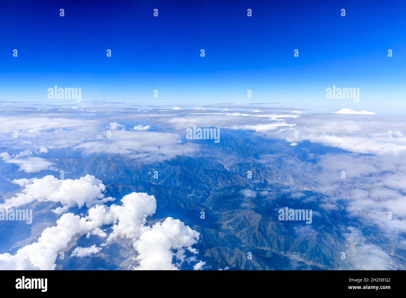 Aerial view above the clouds and mountain peaks on a sunny day.mountain ...
