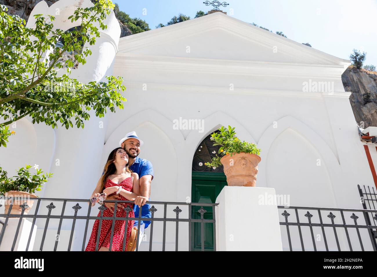 Smiling tourist couple standing at railing Stock Photo - Alamy