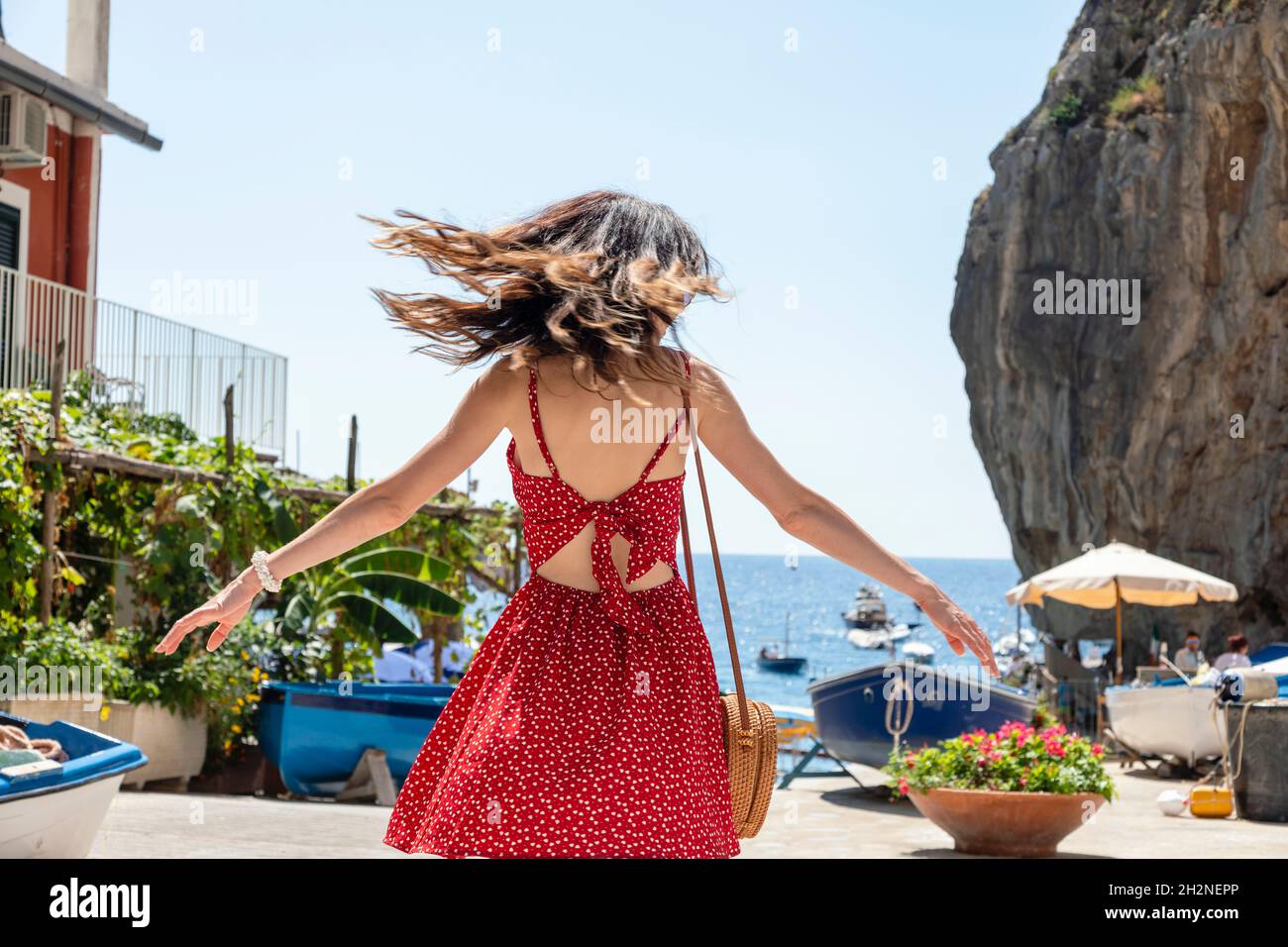 Carefree woman with arms outstretched spinning at beach Stock Photo - Alamy