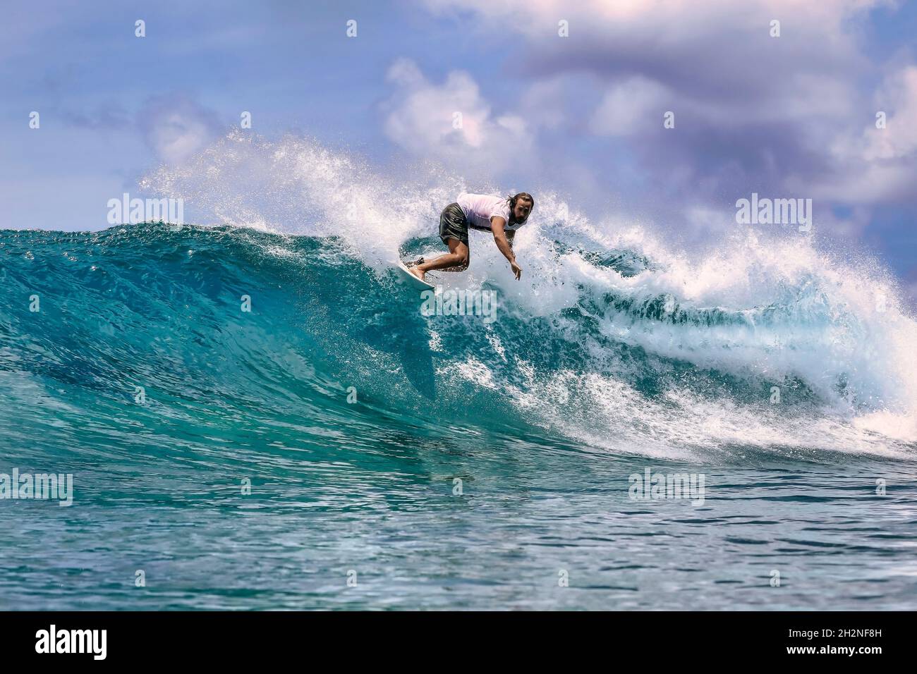 Mid adult man surfing on water Stock Photo - Alamy