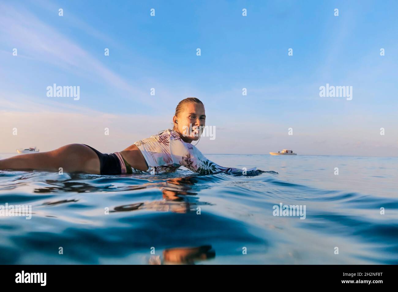 Happy woman sticking out tongue while floating on water Stock Photo - Alamy