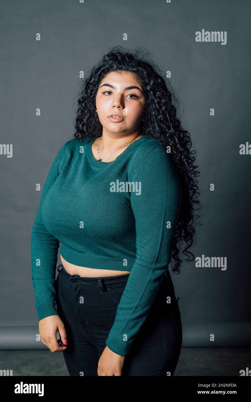 Confident plus size woman standing in studio Stock Photo - Alamy