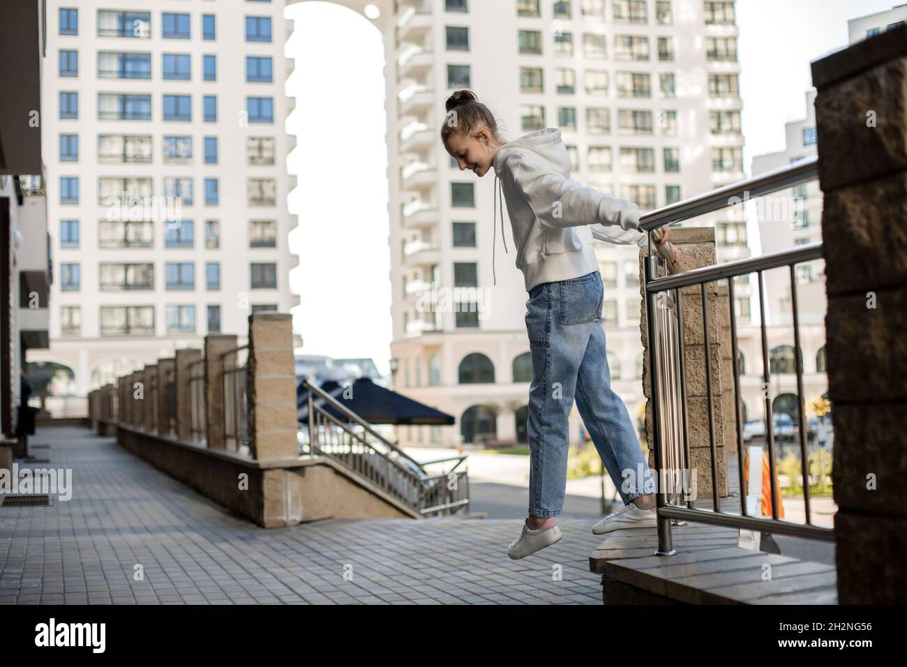 Girl leaning on railing hi-res stock photography and images - Alamy