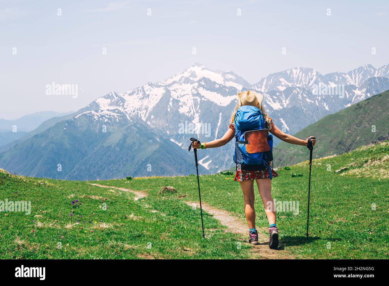Female backpacker hiking on mountain during sunny day Stock Photo - Alamy