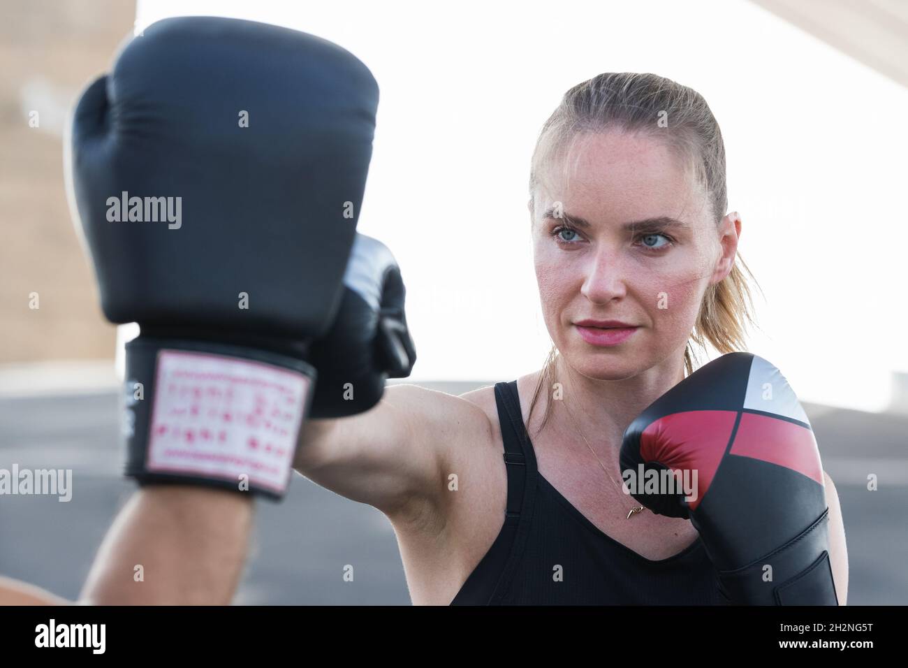 Determined female athlete practicing boxing Stock Photo - Alamy