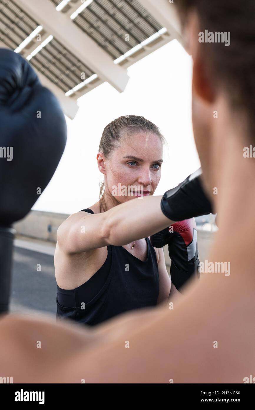 Female athlete with male instructor practicing boxing Stock Photo - Alamy